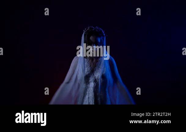 Young phantom of bride is rising her hands up like wings. Young woman ...