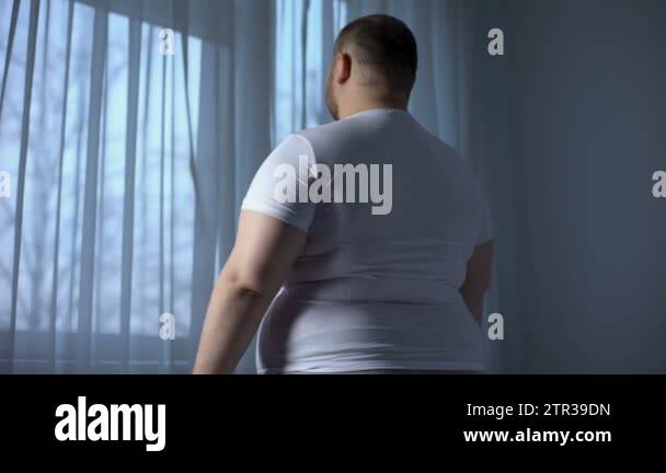 Fat man stretching back muscles, feeling heavy and uncomfortable, poor ...