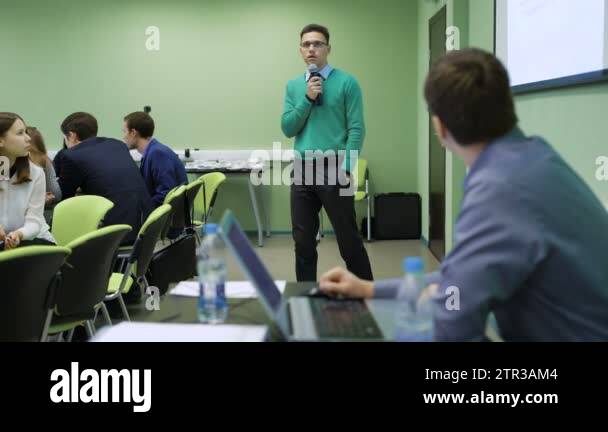 Male student in classroom having an examination at the university ...