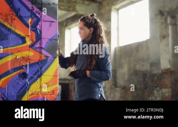 Two friends graffiti painters are drawing abstract images on old ...