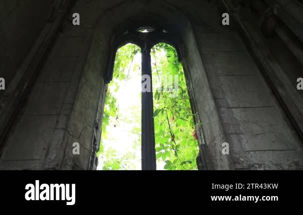 Window opening in ancient stone crypt at graveyard Stock Video Footage ...