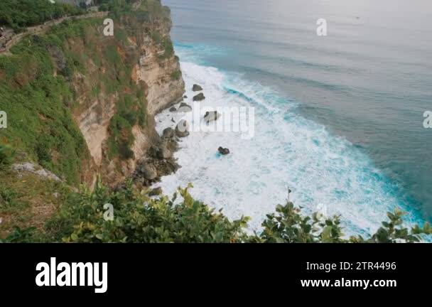 Scenic view of high cliff and deep blue sea at the foot of the rock ...