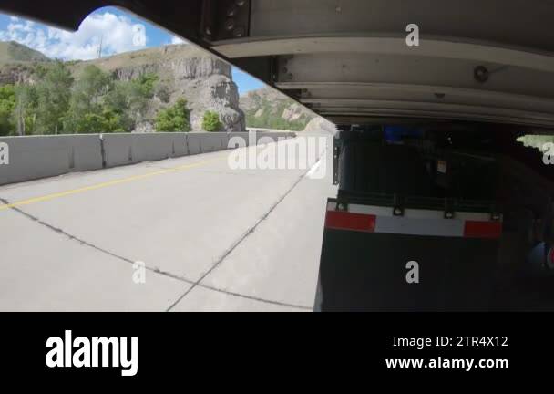 Semi-Truck Trailer Exterior Highway Driving. Camera Angle is underneath ...