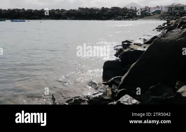 Sea water flowing inside a small bay Stock Video Footage - Alamy