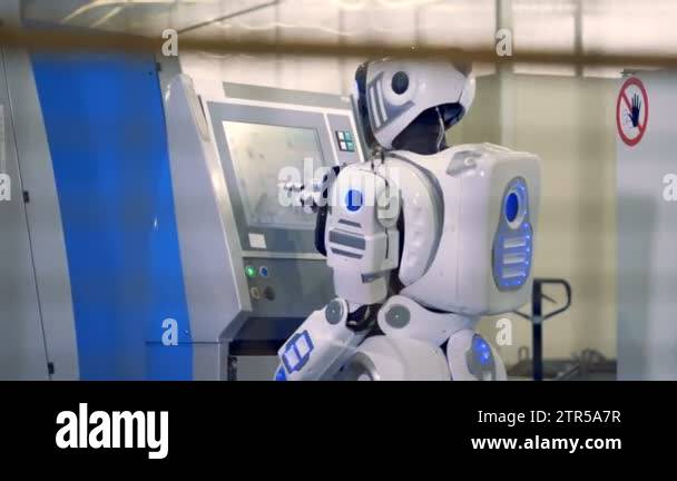 Backside view of a human-like robot pushing different buttons on sensor ...