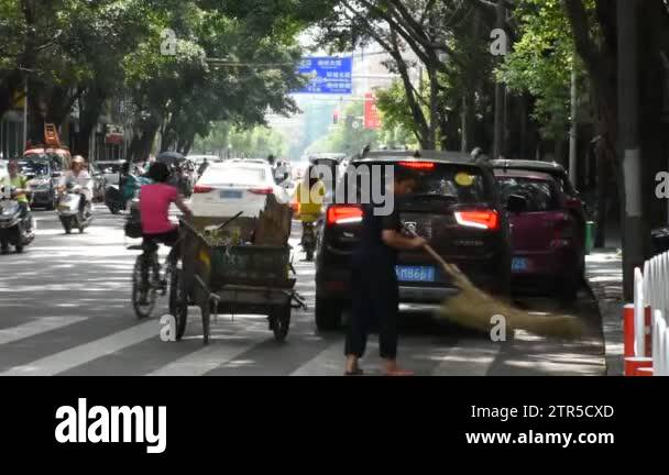 Chinese woman road sweeper working clean and keep garbage and push ...