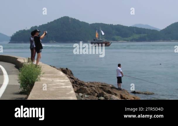 eople do photos of the replicas of the Korean Turtle warships sail by ...