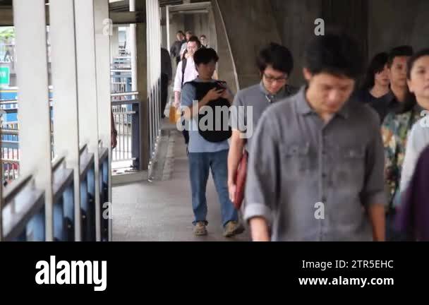 People walking on the walking bridge under the BTS rail train Stock ...