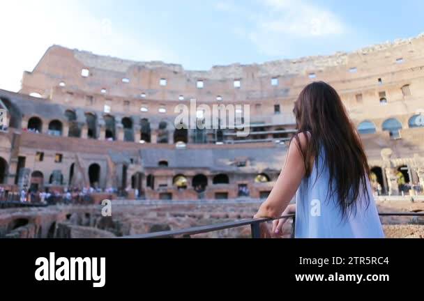 Young female tourist looking at the Colosseum inside in Rome, Italy ...
