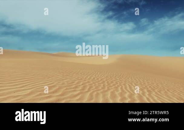 Simple desert landscape with blue cloudy sky over barren sandy dunes at ...