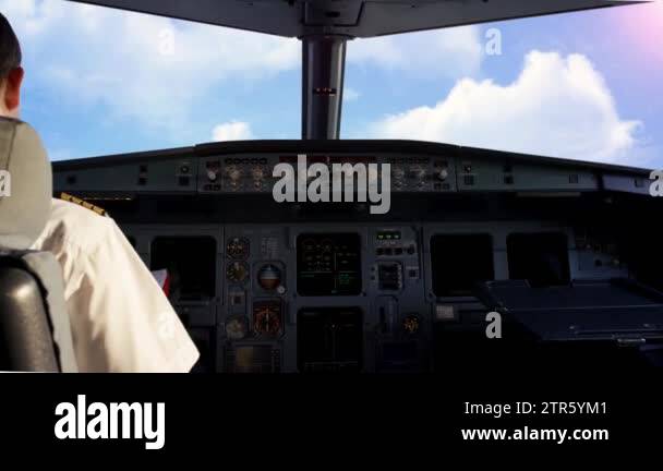 Pilot in the cockpit of a small commercial aircraft above a rural ...