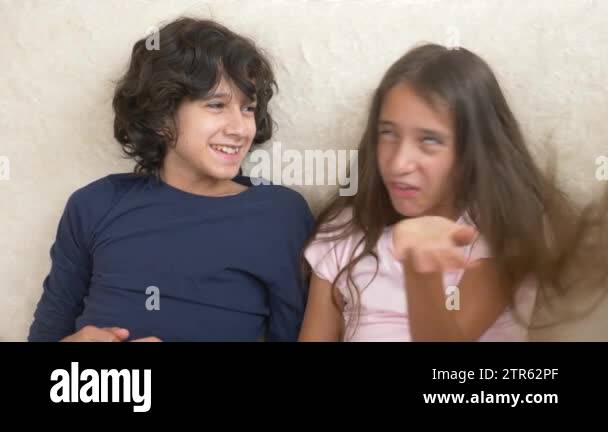 teenagers, twins, brother and sister quarrel, sitting on the couch. 4k ...
