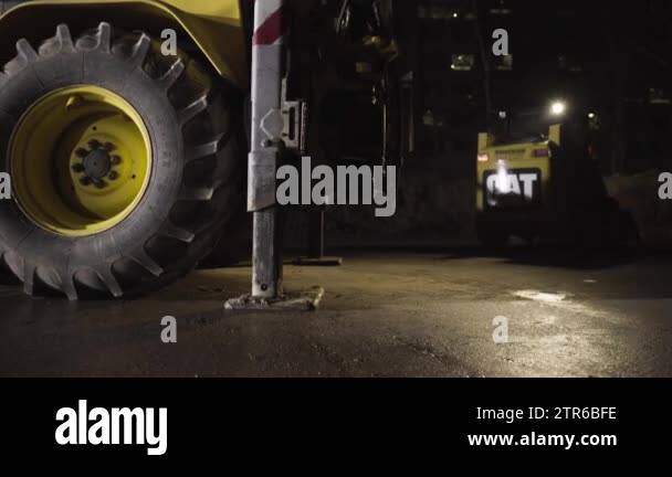 Backhoe is stabilizing legs in the dark background Stock Video Footage ...