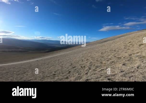 Stabilized camera movement panning left at Batea Mahuida volcano slope ...