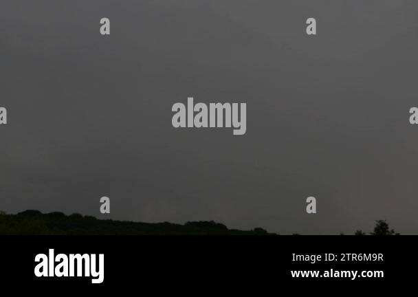 Storm and shower with lightning. Heavy rain with black clouds and wind ...