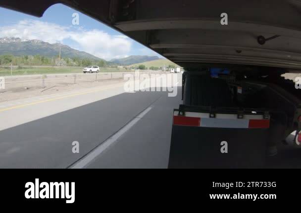 Semi-Truck Trailer Exterior Highway Driving. Camera Angle is underneath ...