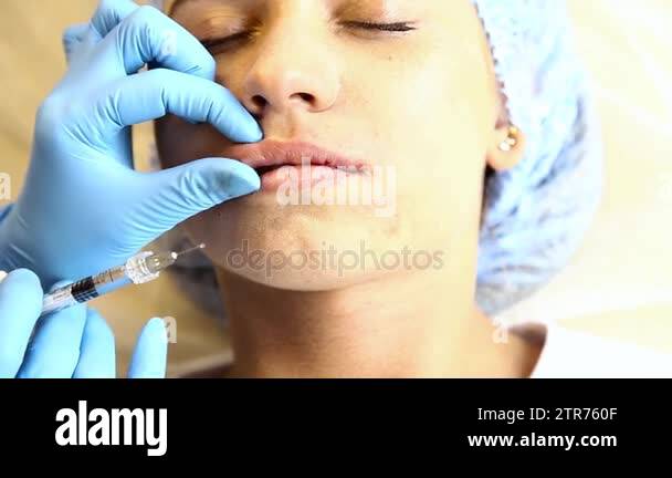 Young woman on lip Augmentation in a clinic. Anesthetic injection ...