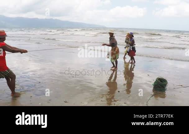 Native fishermen fishing on sea, using traditional technique pulling ...