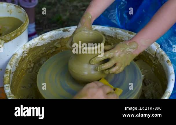 The potter's hands are shaped a cup from a clay. The process of ...