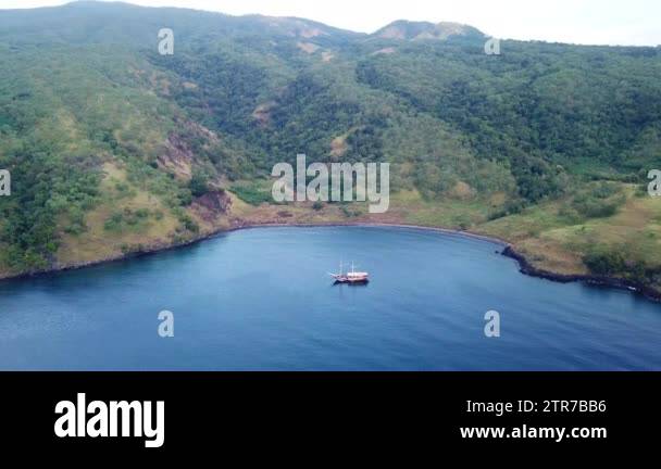 A Pinisi schooner sits at anchor in Beangbeang Bay on Pantar Island in ...