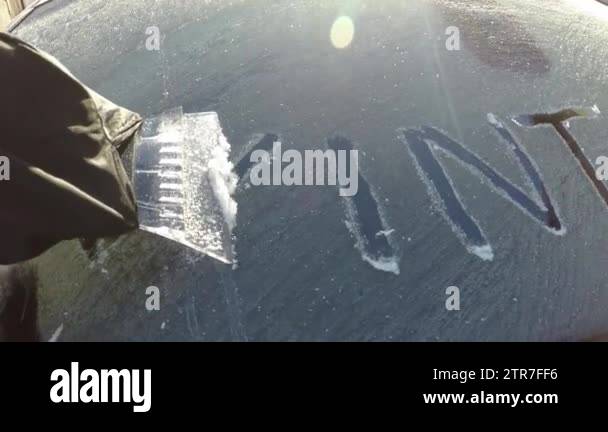 Frosted glass on the car.Removing ice from the car windscreen using ...