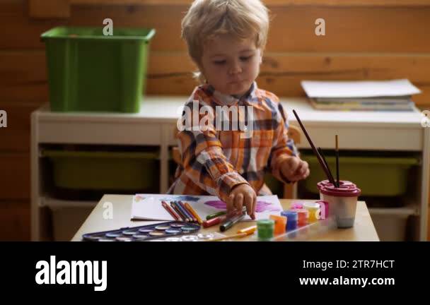 Cute little boy drawing in his album. Concept of early childhood ...
