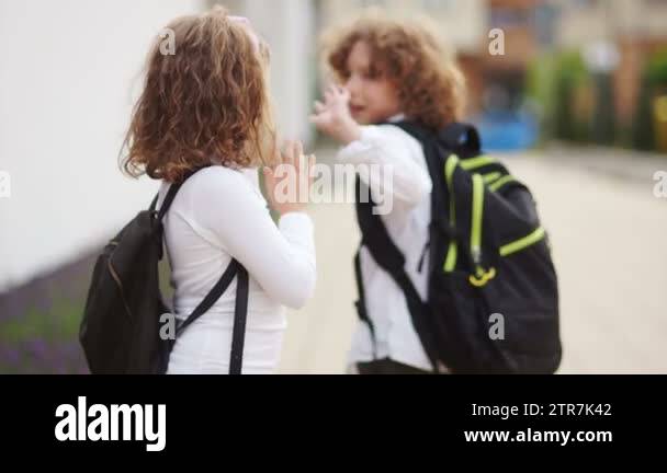 Students say goodbye after graduation. Education in school, happy ...