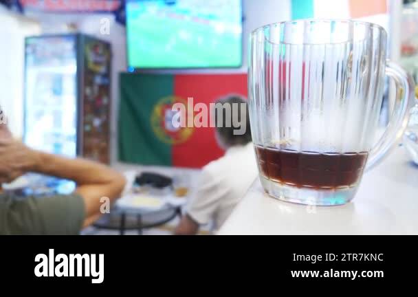 Watching football game on television at local pub. Food, beer. a mug ...