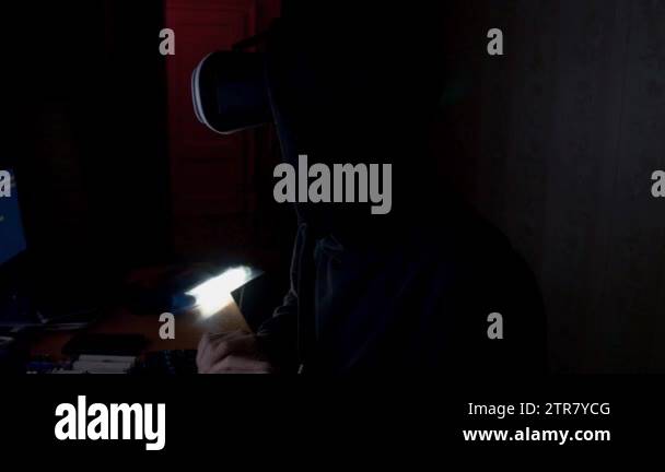 Hacker In Vr Glasses Cracking Code Using Computers In Dark Room Stock