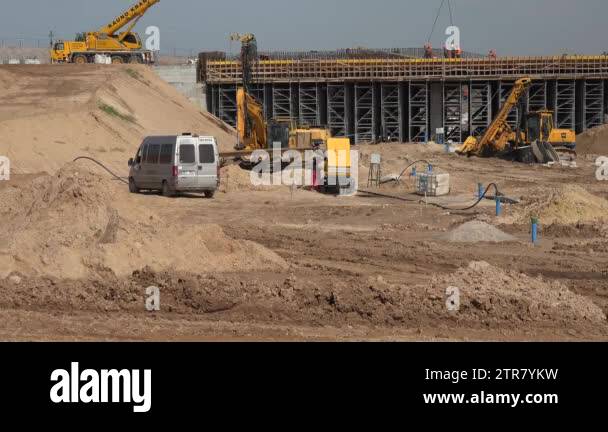 Worker man pouring diesel fuel into generator and highway constructing ...