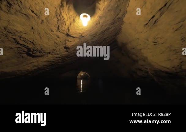 Excursion by boat through the dark cave system, mysterious atmosphere ...