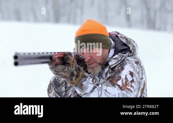 The hunter with double-barreled rifle. The hunter in camouflage targets ...