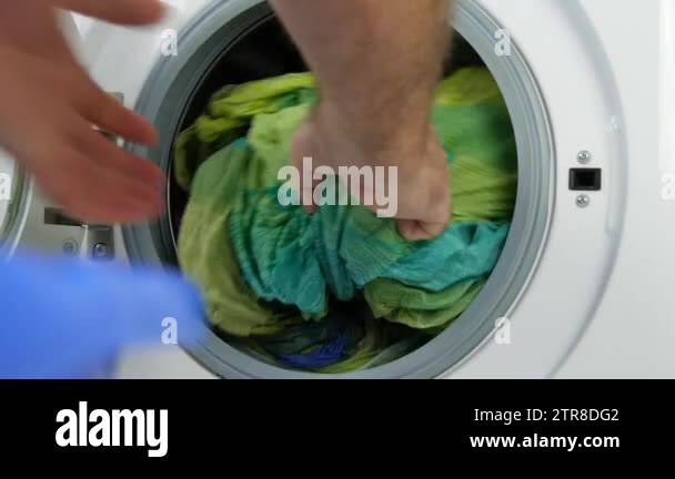 Close View with Man Evacuates the Laundry from Washing Machine (Ultra ...