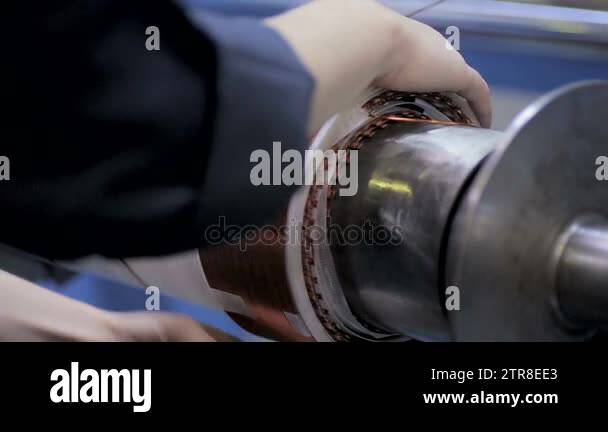 Transformer, engine production. Worker operates with electric cooper ...