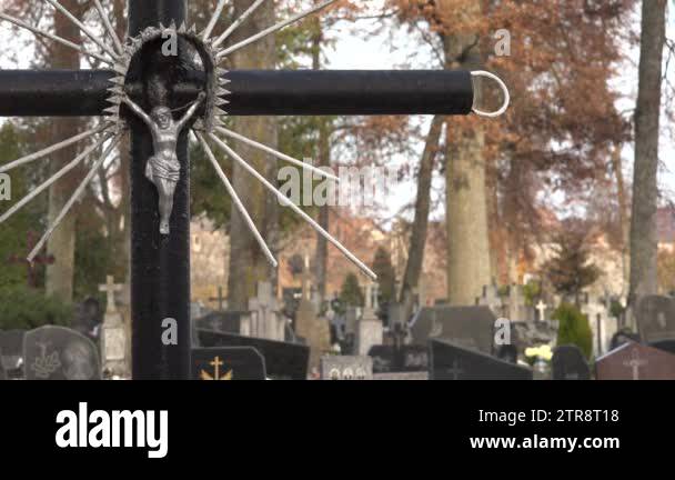 crucified jesus christ on cemetery cross. Graves and trees in graveyard ...