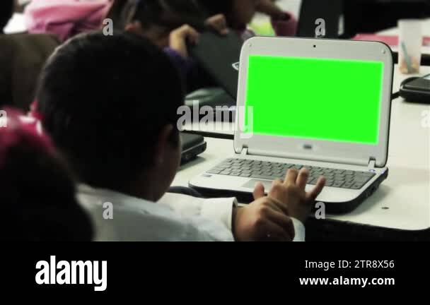 Student Working With Computer With Green Screen. Ready to replace green ...