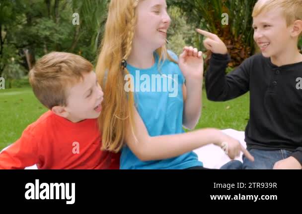 Three siblings poking and tickling each other outside - slowmo handheld ...