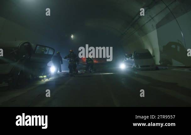 Car accident scene inside a tunnel, firefighters rescuing people from ...
