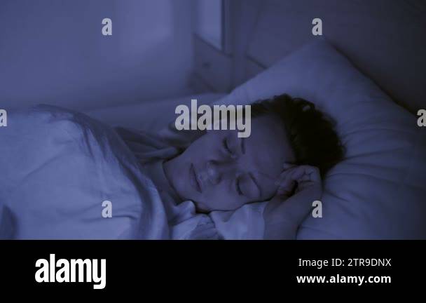 Restless dreams of sleeping woman interrupted by waking up for ...