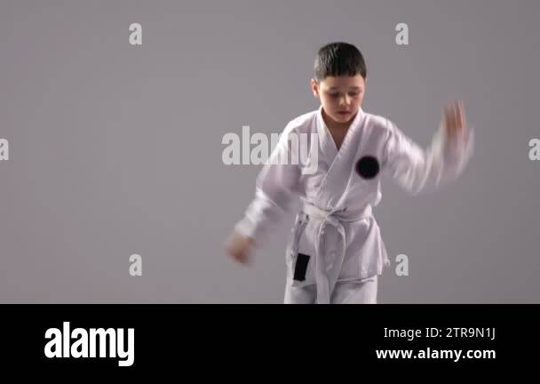 A seven year old boy shows a karate kata, a sequence of various stances ...