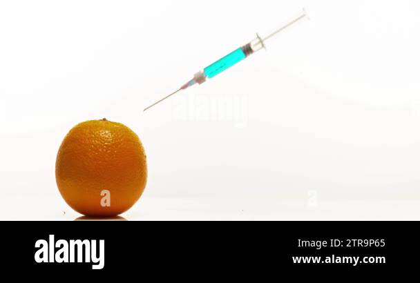 Syringe injecting Treatment into Orange Stock Video Footage - Alamy