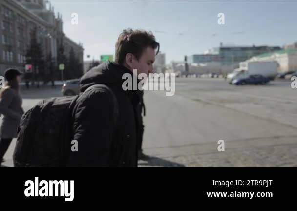 The guy crosses the street through the pedestrian crossing. man with a ...