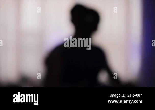 Dancing at night blurred silhouetted couple motion background close up ...