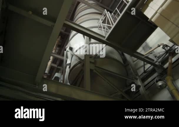 Enormous grey metal tank for limestone storage in premises of ...