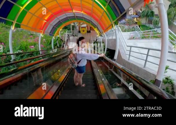 An aerial view of a pretty young woman going down by the colorful ...