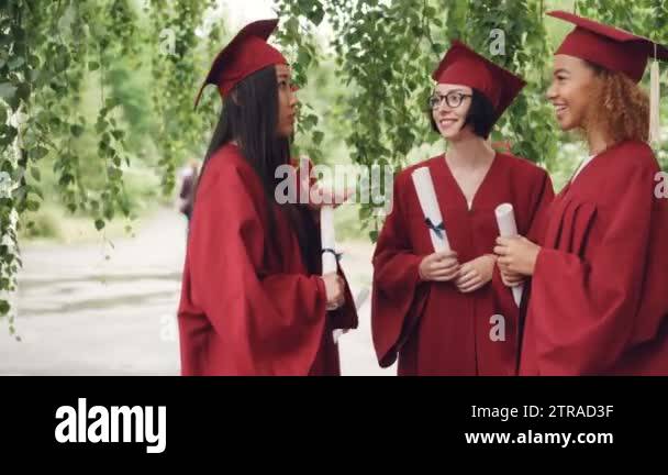 Fellow students are talking and laughing after graduation ceremony ...