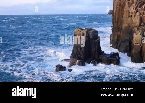 Big strong waves crashing against to sharp rock of the Isle of Skye in ...