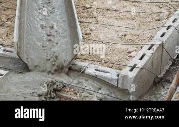 Pouring concrete mix on concreting formwork. an essential part of the ...