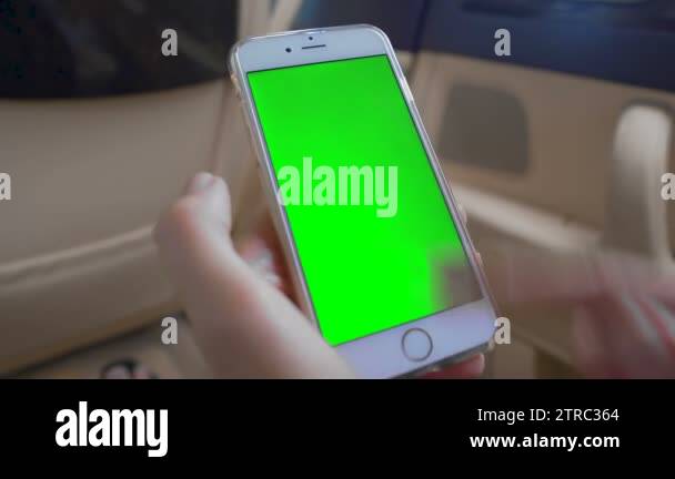 Female hands scrolling on smartphone with green screen, chroma key ...
