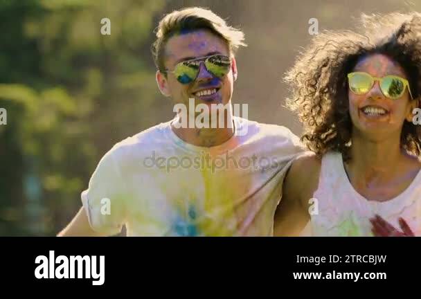 Couples in love having good time, enjoying the Festival of colors in ...